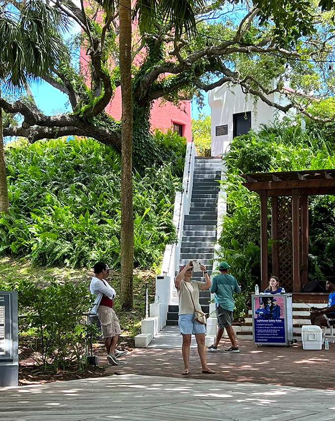 Eager explorers prepare to ascend the lighthouse, unaware that their Instagram followers will soon be green with envy.