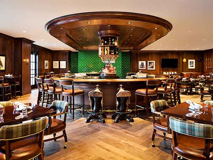 The Yellow Pony Pub's circular bar and emerald tile work create a space where strangers become friends over perfectly mixed cocktails and shared stories.