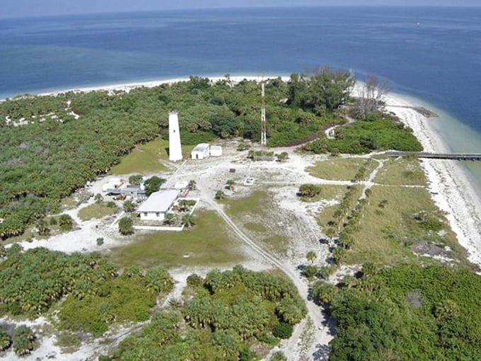 Bird's eye view reveals Egmont Key's strategic position, a slender guardian at Tampa Bay's mouth surrounded by emerald waters.