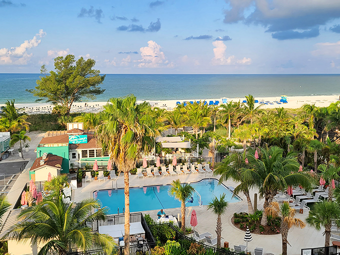 The resort's swimming pool creates a perfect alternative when you're craving water without the waves, surrounded by swaying palms and vacation vibes.