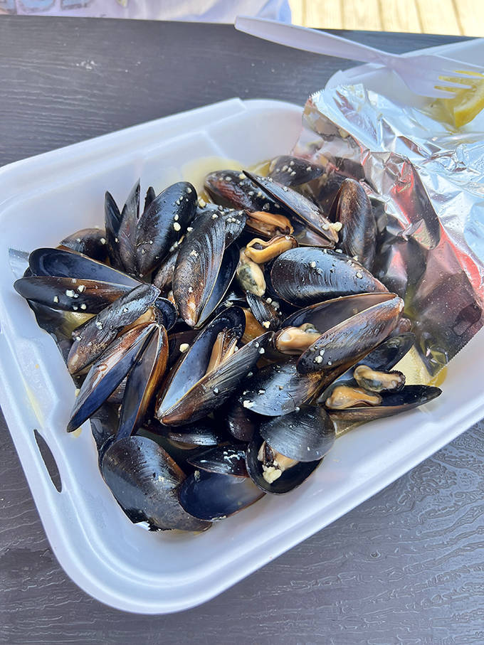 Plump, glistening mussels bathed in garlic butter &ndash; little black shells hiding oceanic treasures that taste like they were harvested minutes ago.