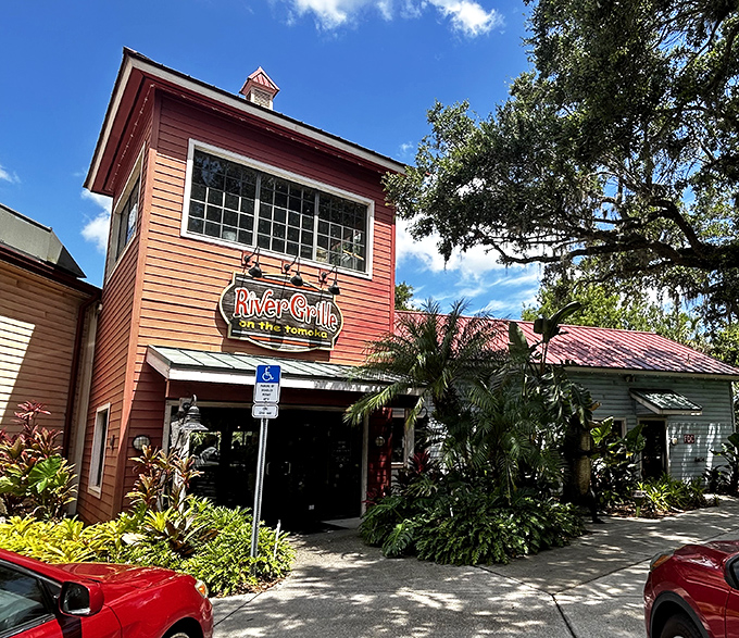 River Grille's cheerful red building surrounded by lush tropical plants creates an inviting entrance to this Tomoka River dining destination.
