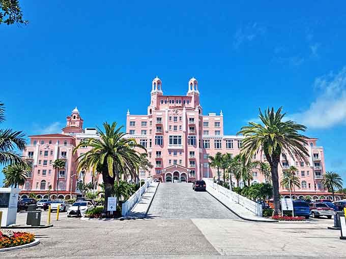 The Don CeSar's iconic pink facade rises majestically against blue skies, earning its nickname as St. Pete Beach's "Pink Palace."