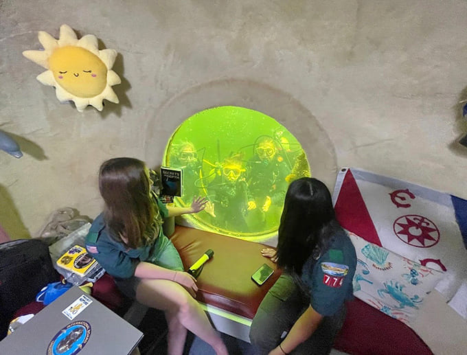 Round windows reveal an underwater world where fish become your roommates for the evening.