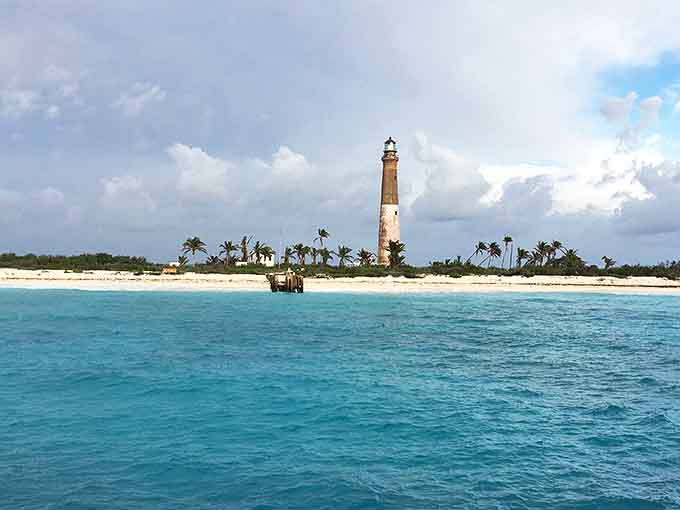 The pristine beach stretches empty and inviting, with water so clear it looks photoshopped.