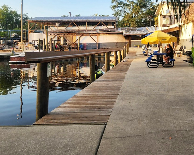 A wooden dock extends over calm waters near The Freezer's, offering the same peaceful Florida scenery that has inspired writers for generations.