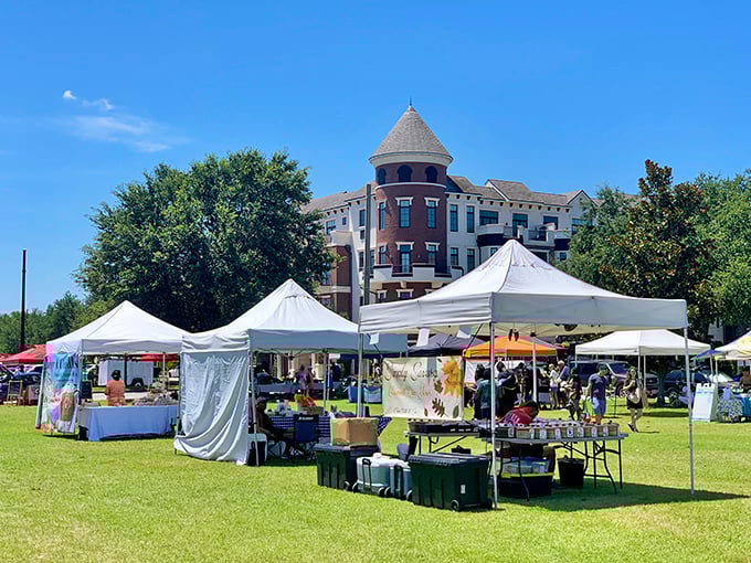 Vendor tents dot the grassy area near Winter Park's historic train depot, creating a picturesque setting for this popular weekend market.