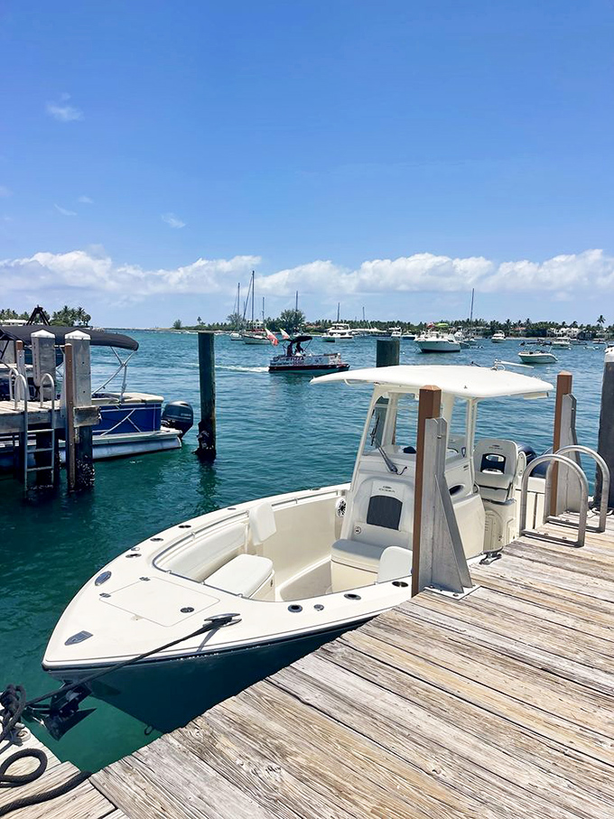 A pristine boat awaits its next adventure at the wooden dock, where the aquamarine waters of Lake Worth Lagoon promise exploration and discovery.