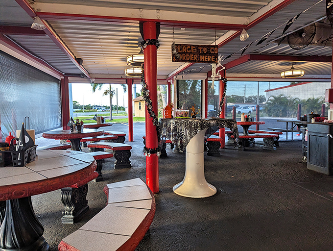 Red poles support more than just the roof &ndash; they frame decades of conversations, first dates, and family meals in this open-air time machine.