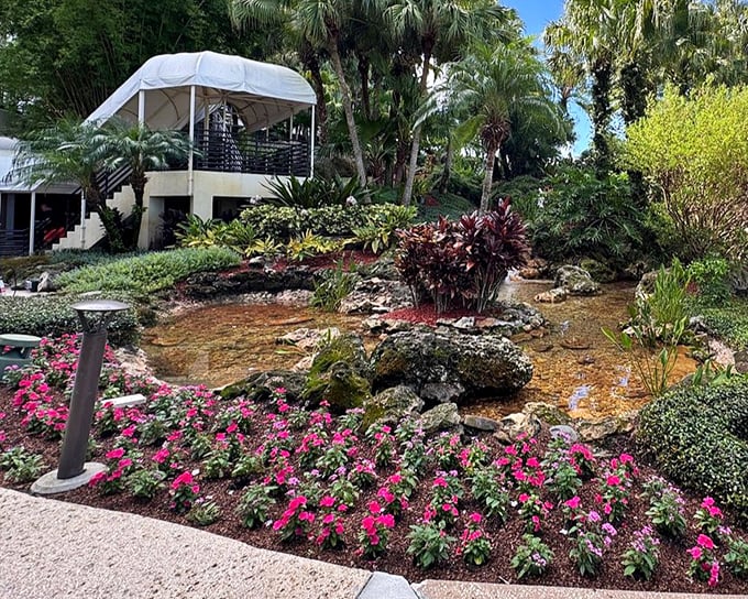 Vibrant flowers and tranquil ponds create peaceful garden pathways, perfect for between-swim strolls.