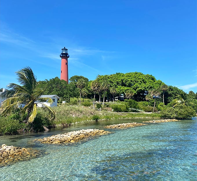 Crystal-clear waters surround the lighthouse grounds, creating a tropical paradise that feels worlds away from ordinary Florida tourism.