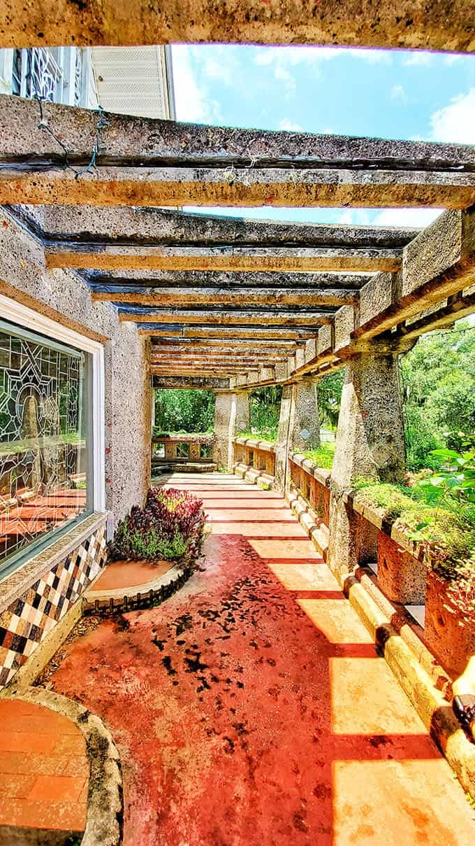 The balcony's weathered concrete and rustic pergola have that perfect patina that only decades of Florida weather can create, and it's absolutely beautiful.