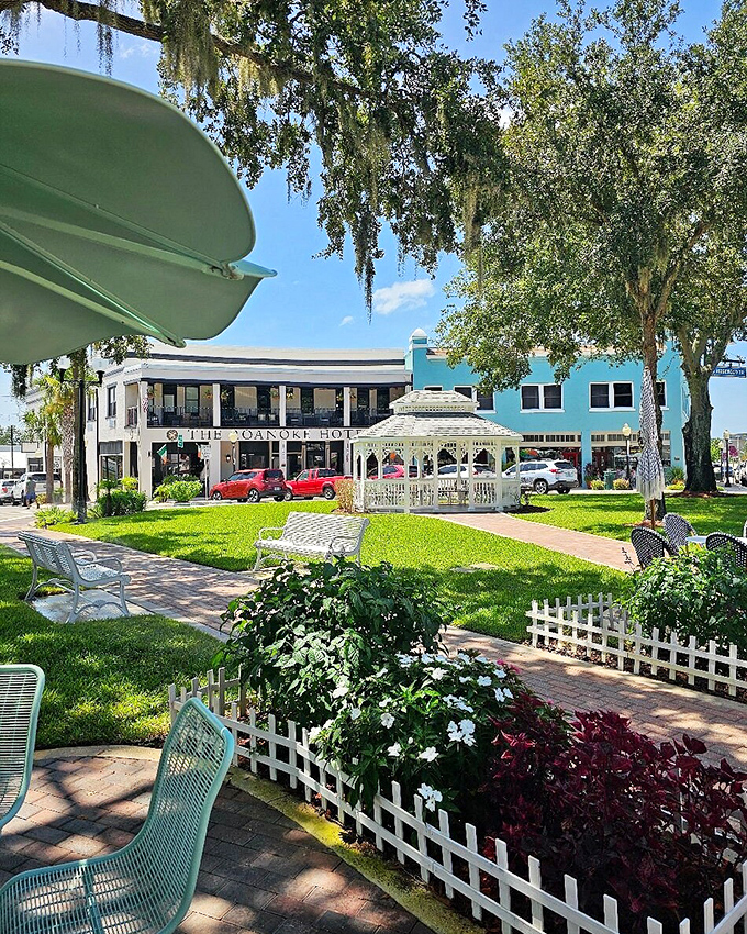 The central green space invites visitors to slow down and actually enjoy being outside, with shade trees providing natural air conditioning that works better than most hotel systems.