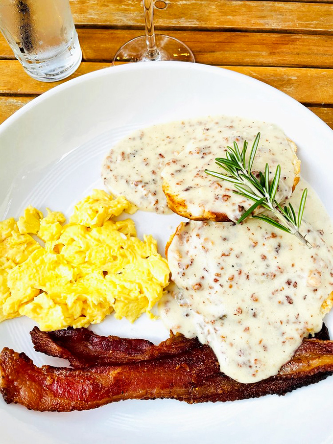 Breakfast nirvana found &ndash; golden scrambled eggs, crispy bacon, and biscuits smothered in sausage gravy create the Southern morning trifecta of perfection.