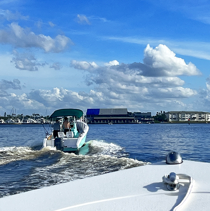 A pleasure craft cuts through Charlotte Harbor's waters, leaving behind a frothy signature that dissolves almost as quickly as your shopping budget.