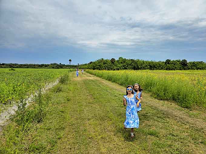 Young adventurers navigating paths between towering blooms, discovering that the best playgrounds don't need swings when you've got flowers and imagination.