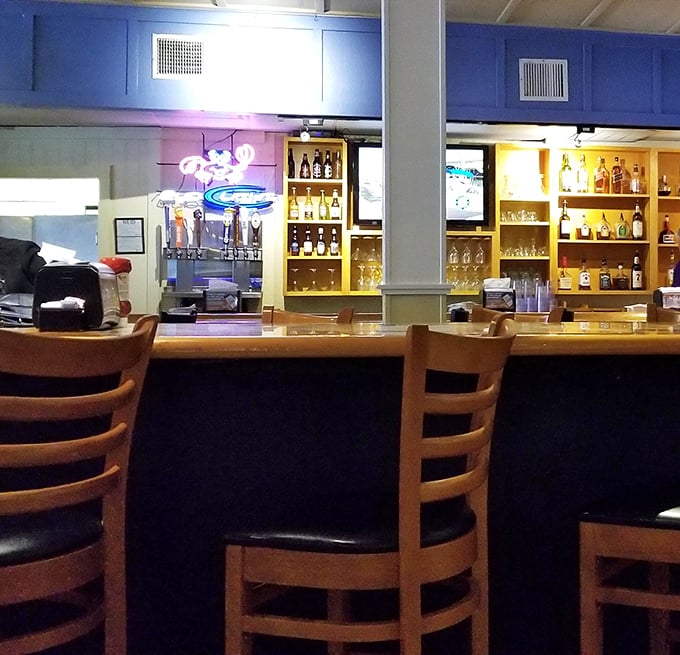 The bar area invites you to pull up a stool, order something cold, and watch the bartenders work their magic while seafood aromas fill the air.