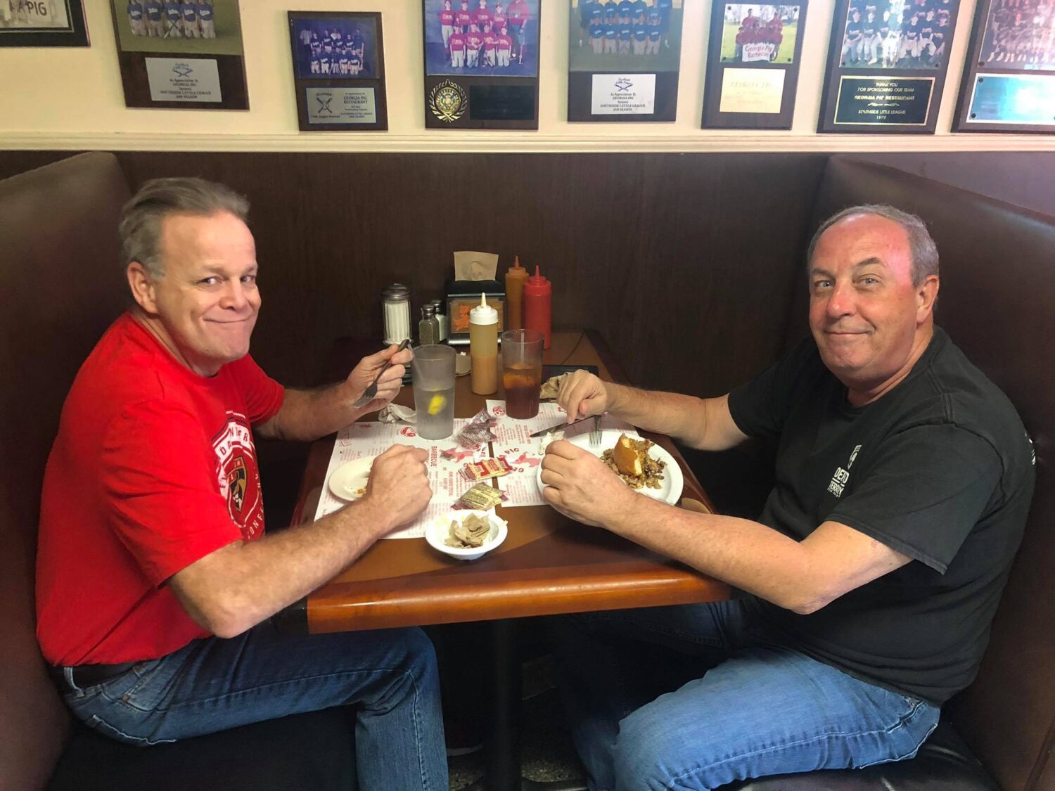 The true measure of a great barbecue joint: happy diners sharing stories and creating memories over plates of smoky goodness in comfortable booths.