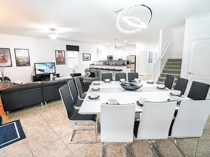 Modern meets galactic in this dining area where family meals happen around a sleek white table&mdash;perfect for planning tomorrow's adventures.