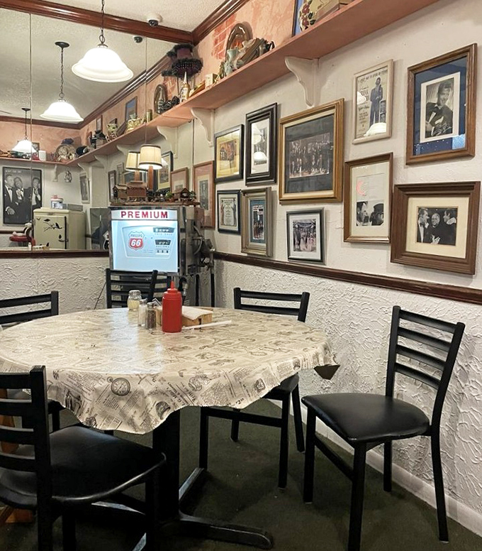 Every inch of wall space tells a story in this cozy dining room, where vintage photographs and memorabilia create a museum you can eat in.