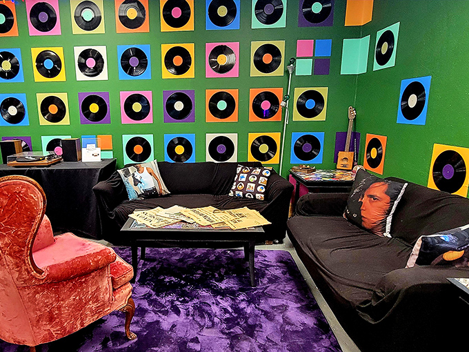A cozy listening lounge decorated with colorful vinyl records invites visitors to sit, chat, and share discoveries with fellow music enthusiasts.