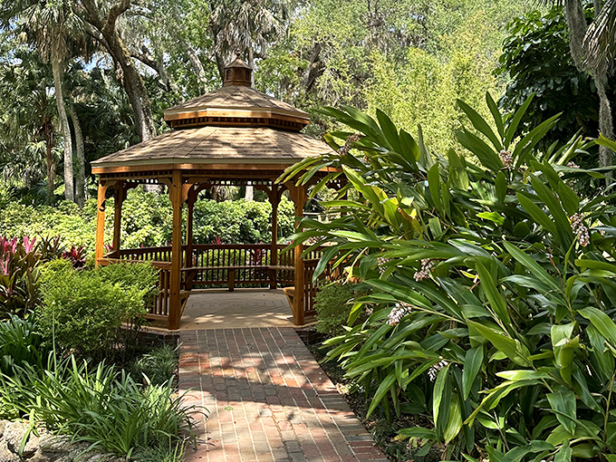 This charming gazebo creates the perfect frame for the surrounding botanical masterpiece.