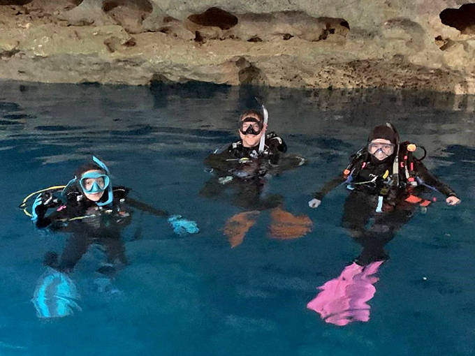 Scuba divers explore crystal-clear waters that have remained unchanged for millennia, a rare constant in our ever-changing world.