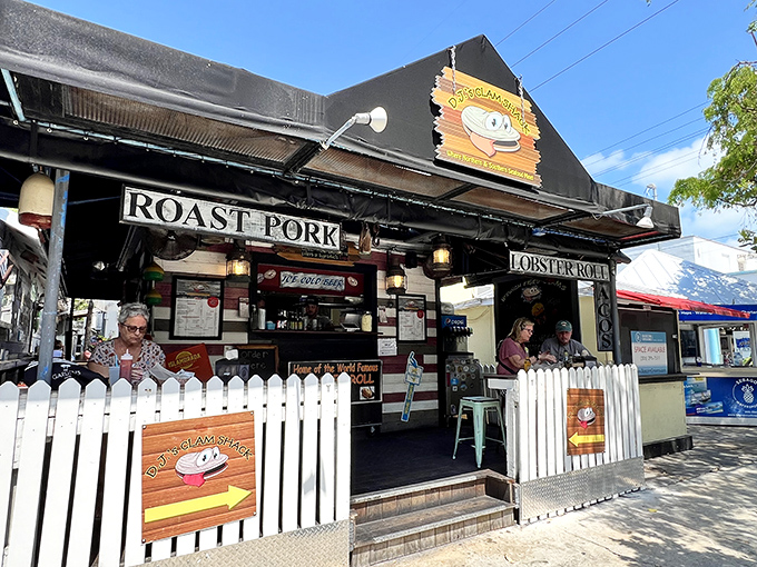DJ's Clam Shack's compact black building with white picket fence stands out among colorful Duval Street shops as a seafood lover's paradise.