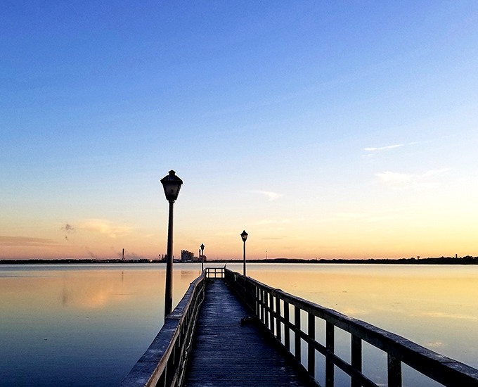 Lake Parker's long pier invites visitors to walk out over waters that change from blue to gold as the sun makes its daily journey across the sky.