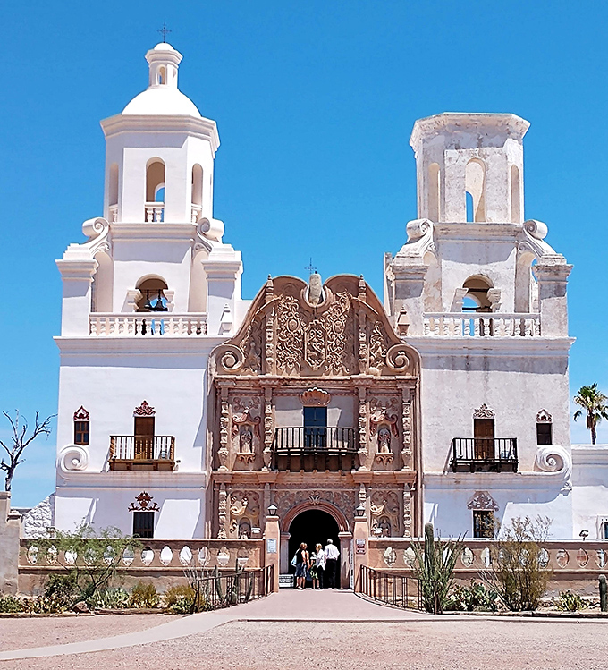 San Xavier del Bac Mission's white towers gleam against the blue Arizona sky. This stunning Spanish colonial church has been called the "White Dove of the Desert."