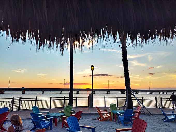 Sunset paints the sky behind the tiki bar, turning an ordinary evening into something magical.