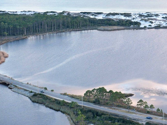 The narrow coastal road of 30A winds between white sand dunes and rare coastal dune lakes, offering drivers glimpses of natural Florida.