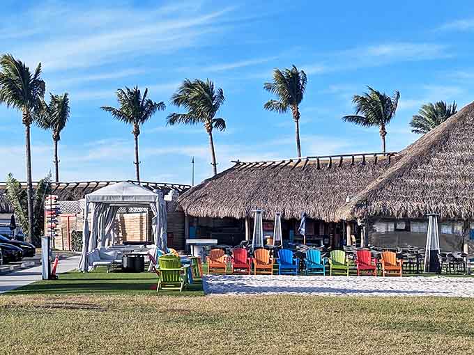 The colorful chairs on the sand are perfectly positioned for watching boats and soaking up the sun.