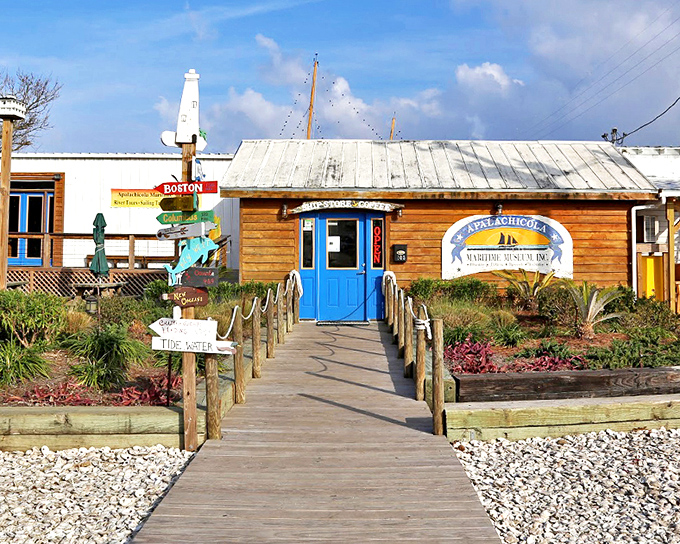 The welcoming facade of Apalachicola Maritime Museum beckons visitors with its rustic charm and bright blue door &ndash; nautical history without the stuffiness.