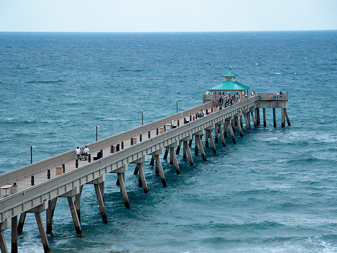 The iconic pier stretches like a runway into the Atlantic, where the turquoise waters seem to whisper, "Come on in, the temperature's perfect!"