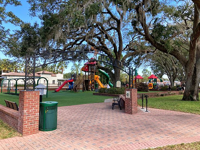 Downtown Auburndale City Park welcomes visitors with majestic oak trees and brick pathways, creating an instant sense of tranquility in the heart of the city.