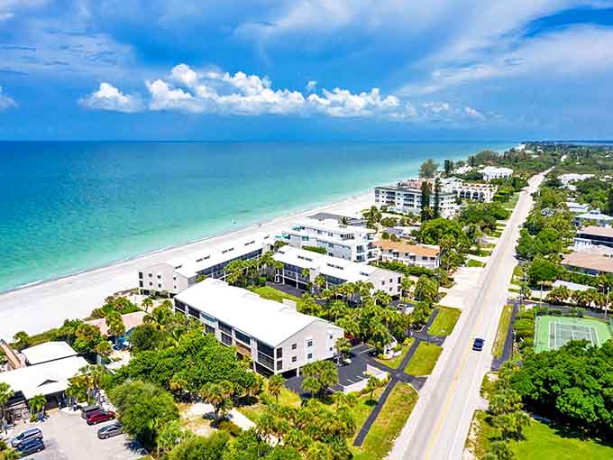 Aerial view of Englewood's pristine coastline where turquoise waters meet white sand beaches without the crowds you'd expect in paradise.