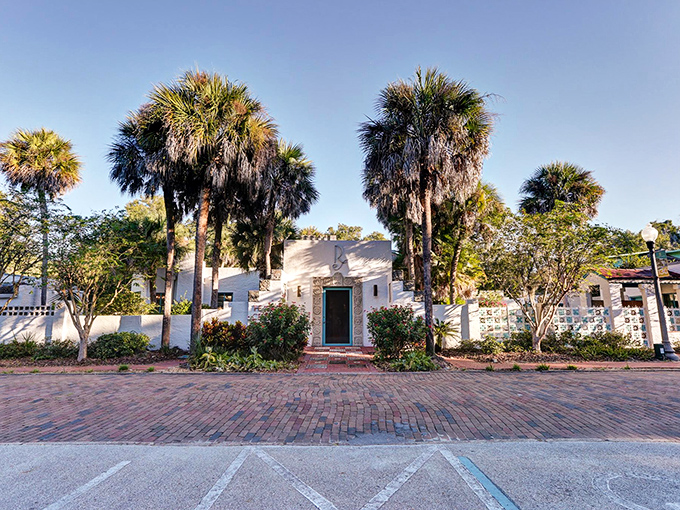 Palm sentinels guard the unassuming entrance to Maitland's hidden treasure, where Mayan mysteries await beyond the teal door.