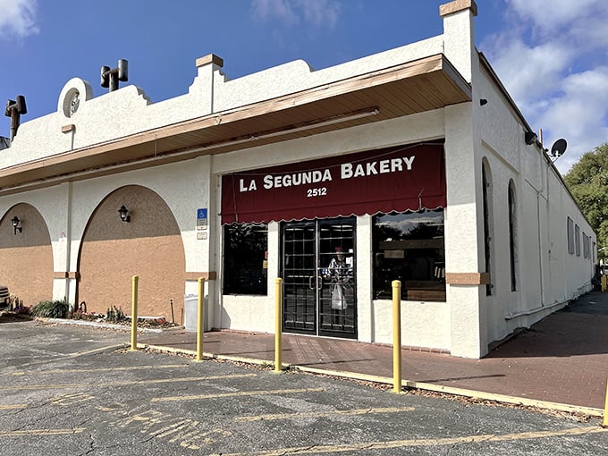 La Segunda's iconic white stucco exterior with its welcoming red awning stands as a beacon of Cuban culinary tradition in Tampa's landscape.