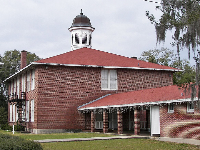The iconic red-brick exterior and distinctive cupola of the Old Lutz Schoolhouse stand as a testament to early 20th century educational architecture.