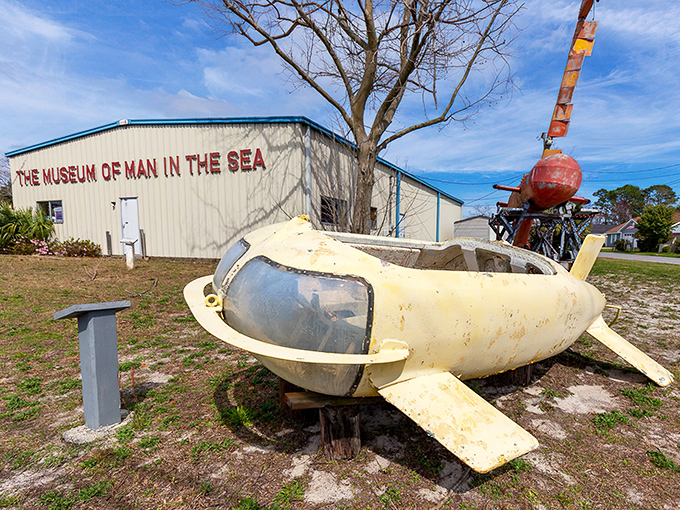 The unassuming exterior of the Museum of Man in the Sea houses treasures from beneath the waves, with vintage submersibles standing guard like yellow sentinels.