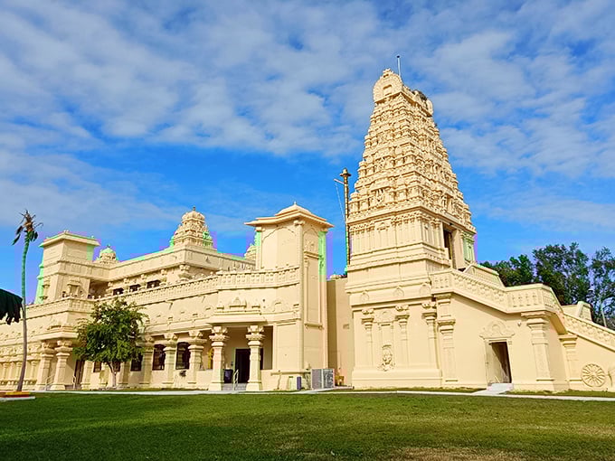 The Hindu Temple of Florida stands majestically against the Tampa sky, its cream-colored gopuram reaching heavenward like an architectural prayer.