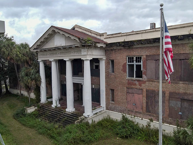 Those columns still standing proud like they're waiting for students who'll never return, a testament to when schools were built like temples to education.