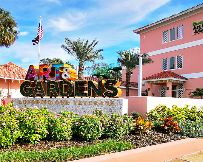 The vibrant pink facade welcomes visitors with tropical palms standing guard, promising an artistic escape from Florida's usual tourist haunts.