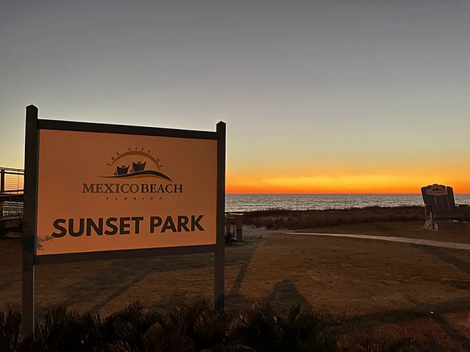 The welcoming sign to Sunset Park glows with the day's final light, promising nature's most reliable magic show.