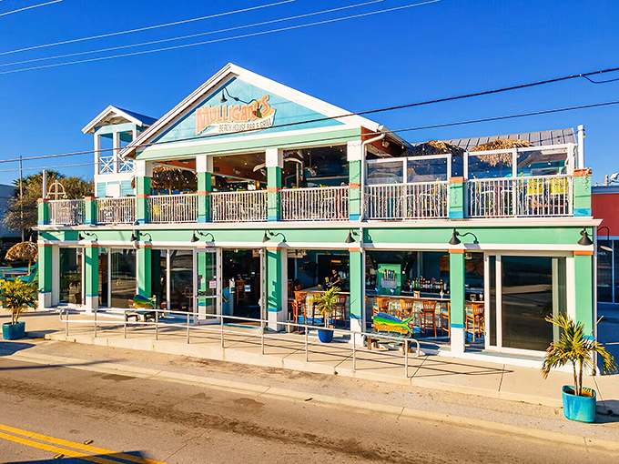 The mint-green facade of Mulligan's Beach House beckons like a tropical mirage, promising seafood treasures and vacation vibes without the airfare.
