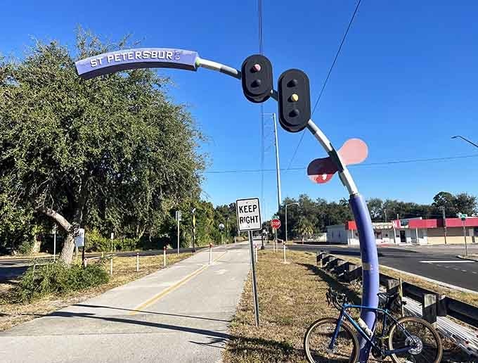 The St. Petersburg entrance welcomes trail users with whimsical art that proves even traffic signals can have personality when they retire from road duty.