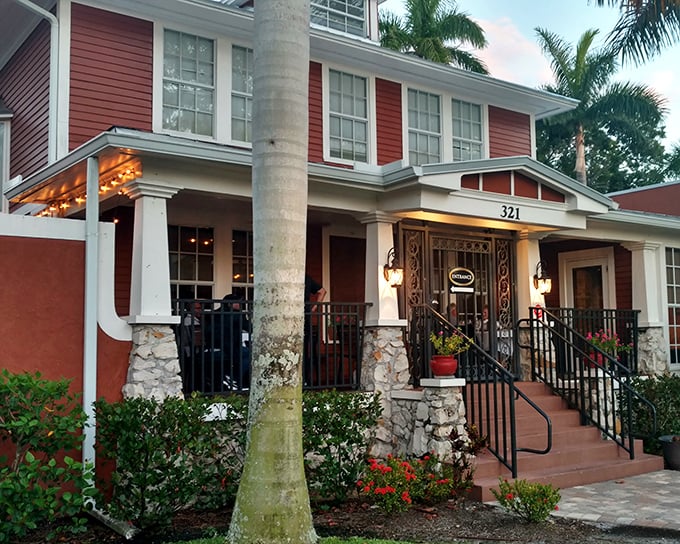 The welcoming facade of Carmelo's Italian Ristorante glows with warmth against the Florida palms, promising authentic flavors within.