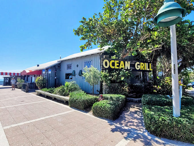 That cheerful yellow "OCEAN GRILL" sign beckons like a lighthouse guiding hungry sailors to shore and safety.