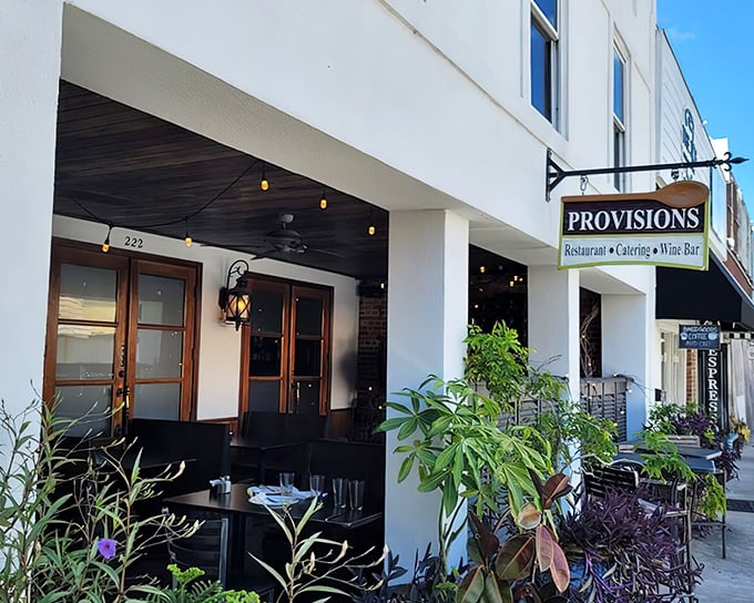 That classic storefront charm with the black awning and wooden doors practically whispers "something delicious is happening inside."